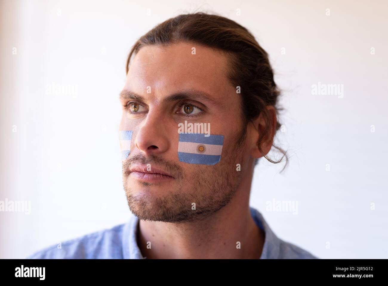 Image of serious caucasian man with flags of argentina on face Stock ...