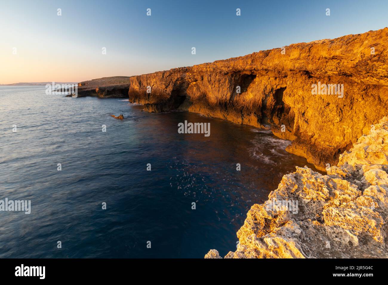 Amazing sunrise over the rising cliffs and rocks in Malta, with ...
