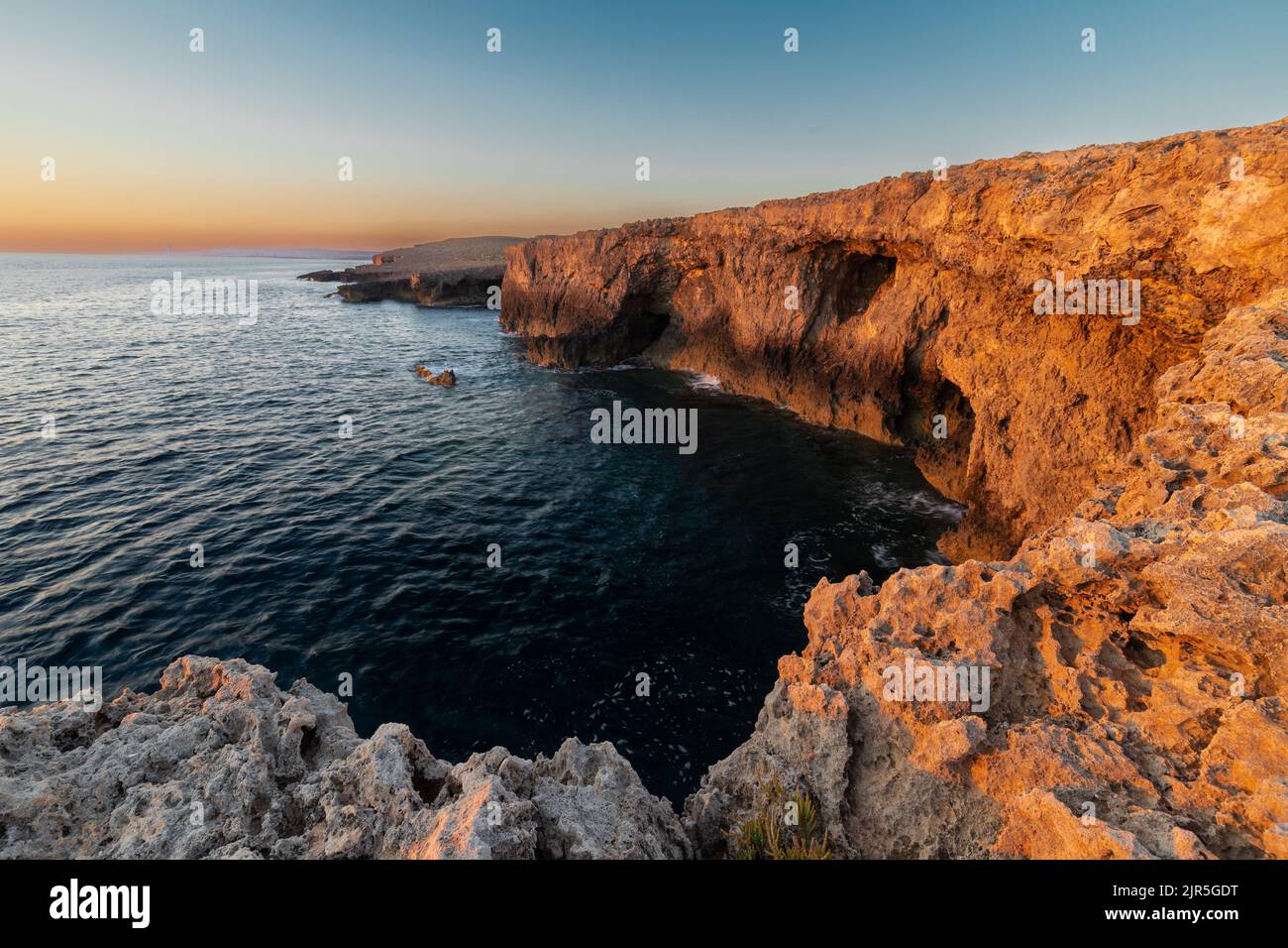 Amazing sunrise over the rising cliffs and rocks in Malta, with ...