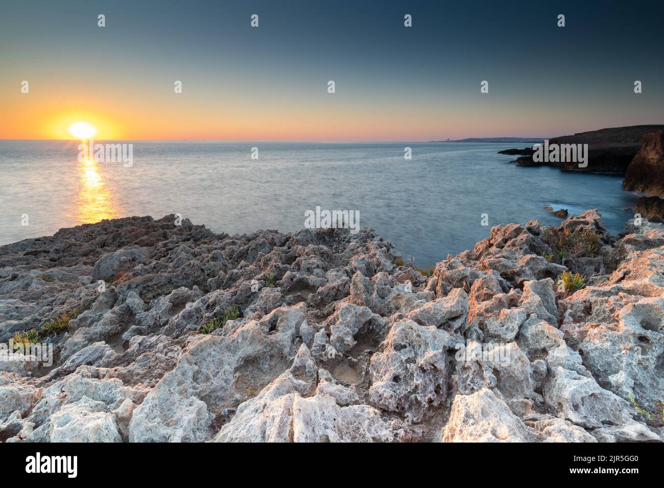Amazing sunrise over the rising cliffs and rocks in Malta, with ...