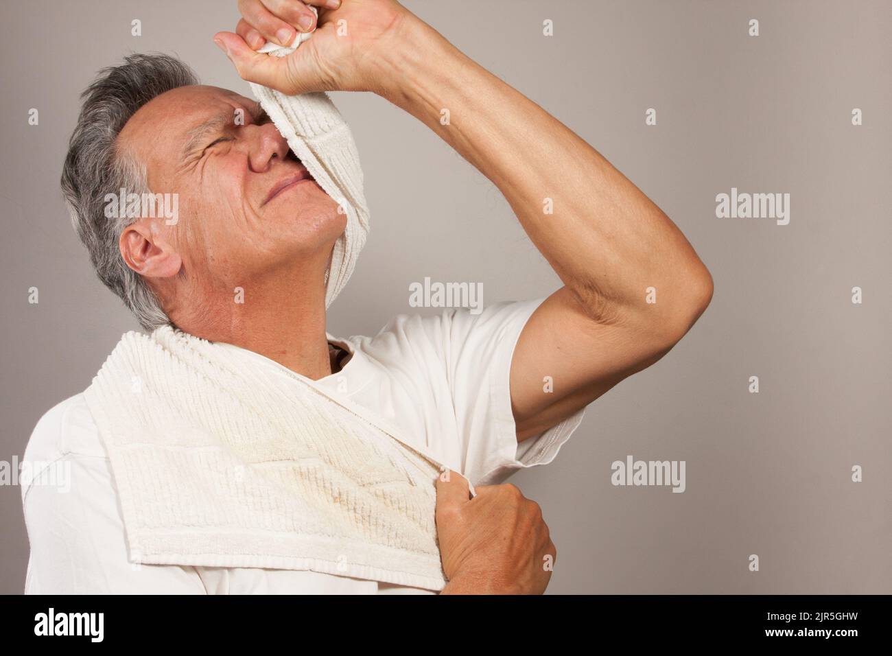 Mature Man 60plus doing back of the neck stretches for back and neck ...