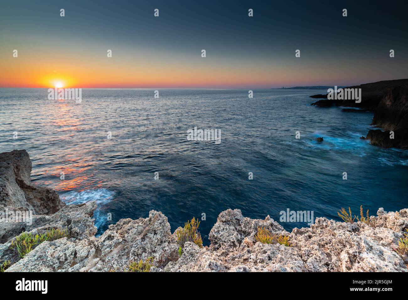 Amazing sunrise over the rising cliffs and rocks in Malta, with ...
