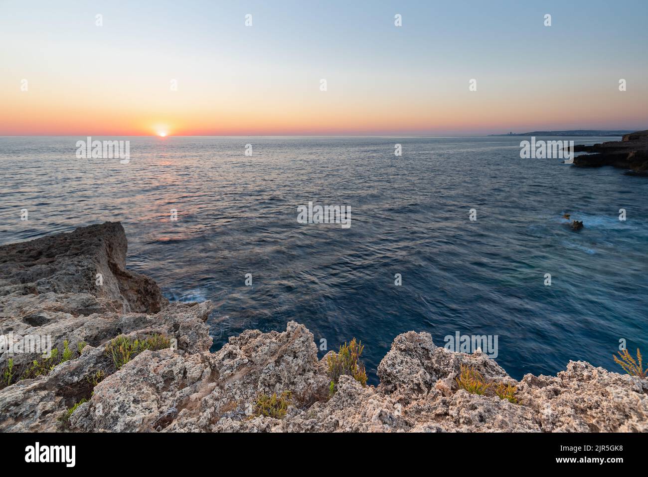 Amazing sunrise over the rising cliffs and rocks in Malta, with ...