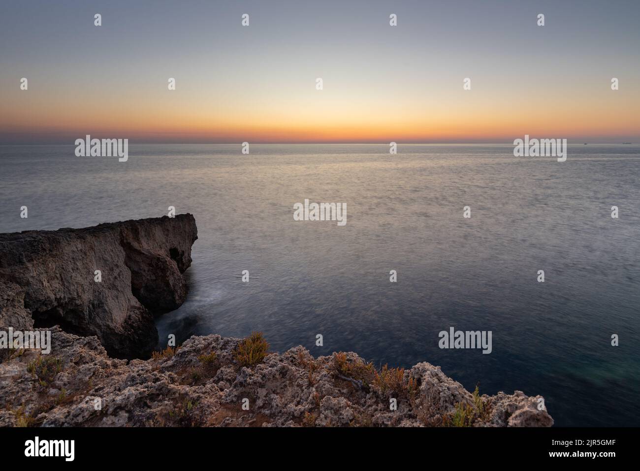 Amazing sunrise over the rising cliffs and rocks in Malta, with ...