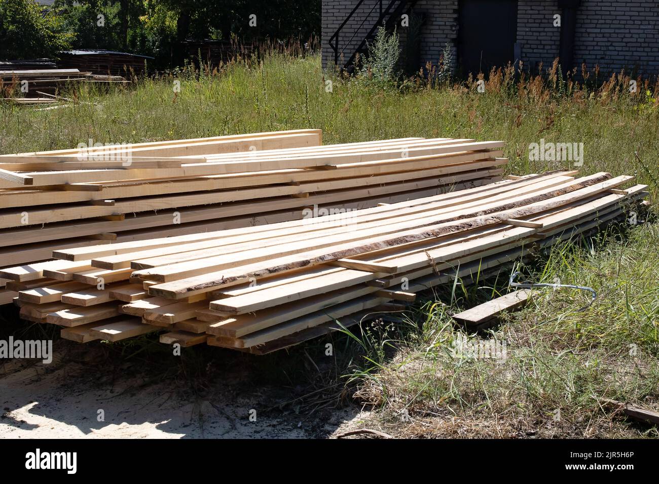 Folded finished boards at the sawmill close up Stock Photo - Alamy