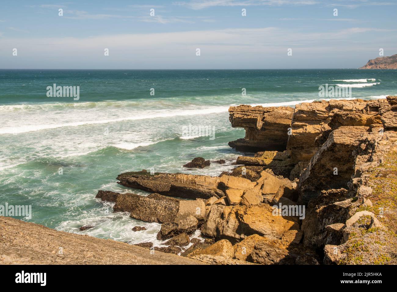 Cliff with loose rocks and persistent waves on the Portuguese Atlantic ...