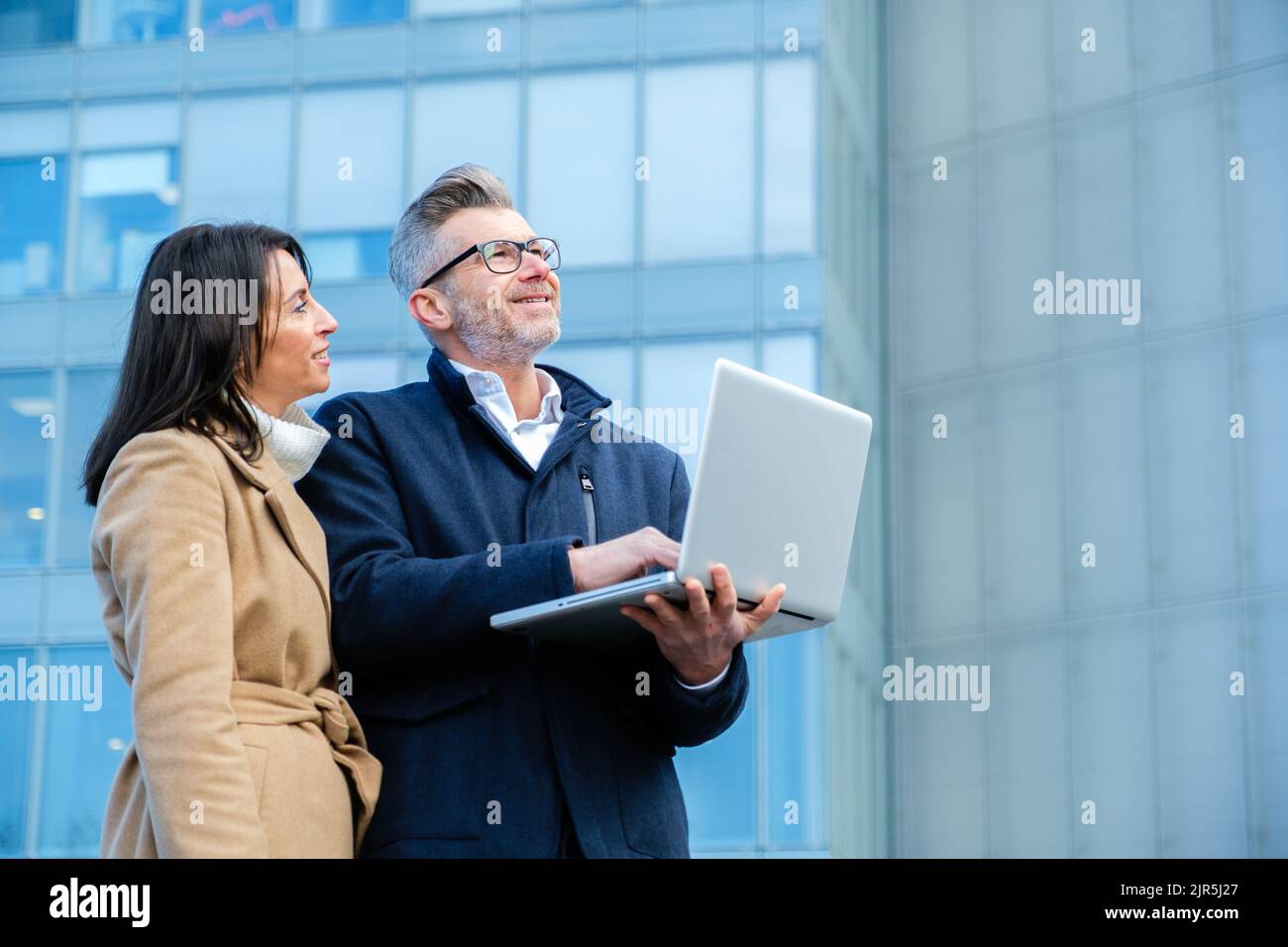 Business people team meeting and working outside with computer in front ...