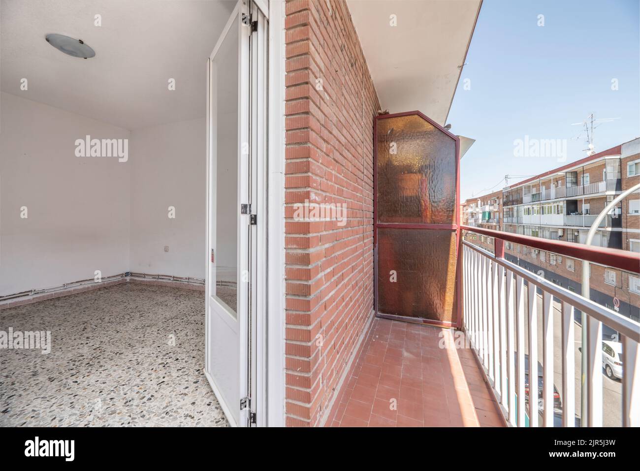 Long terrace of an urban residential house with metal railing, exposed ...
