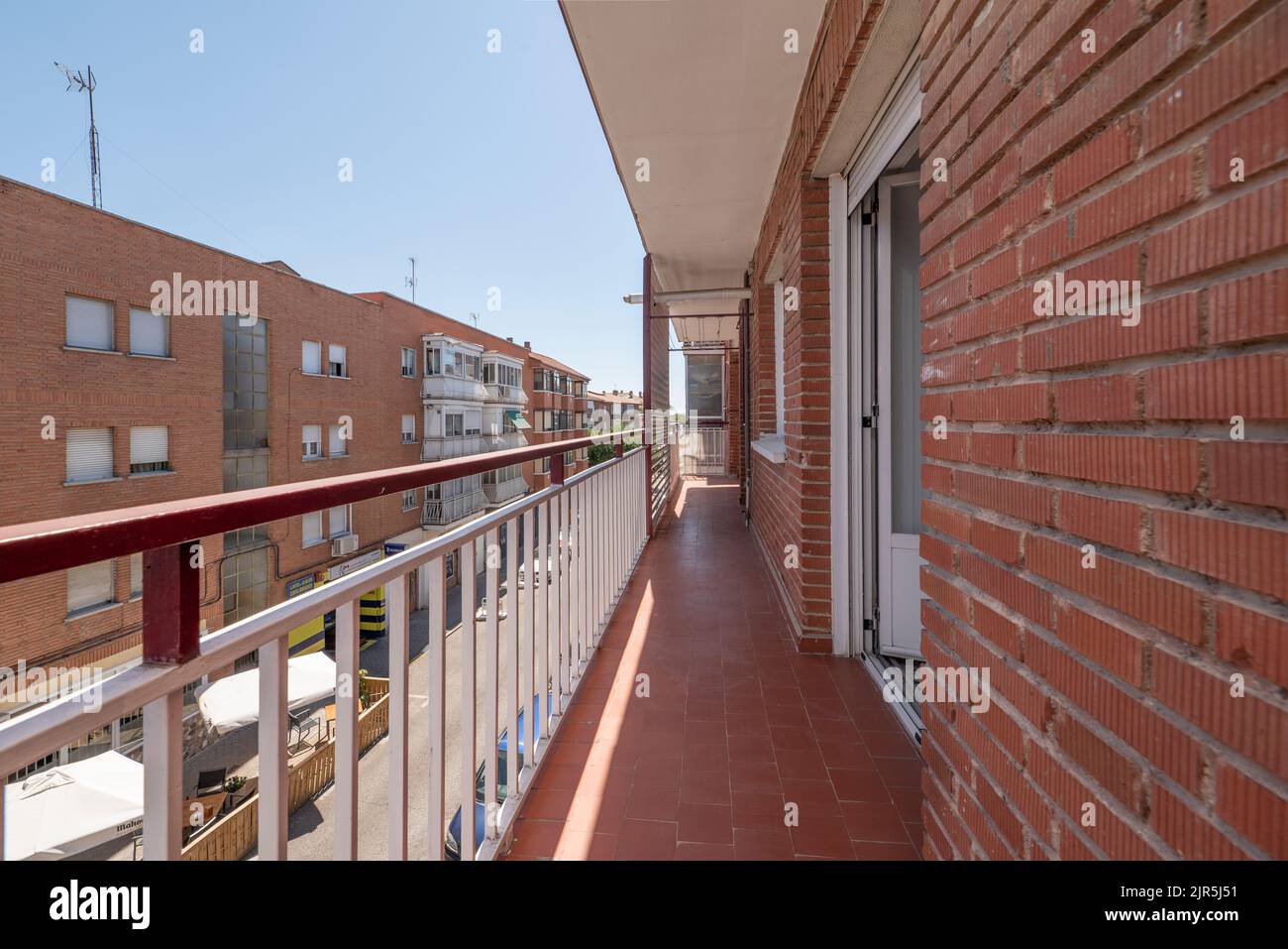 Long terrace of an urban residential house with white metal railing ...