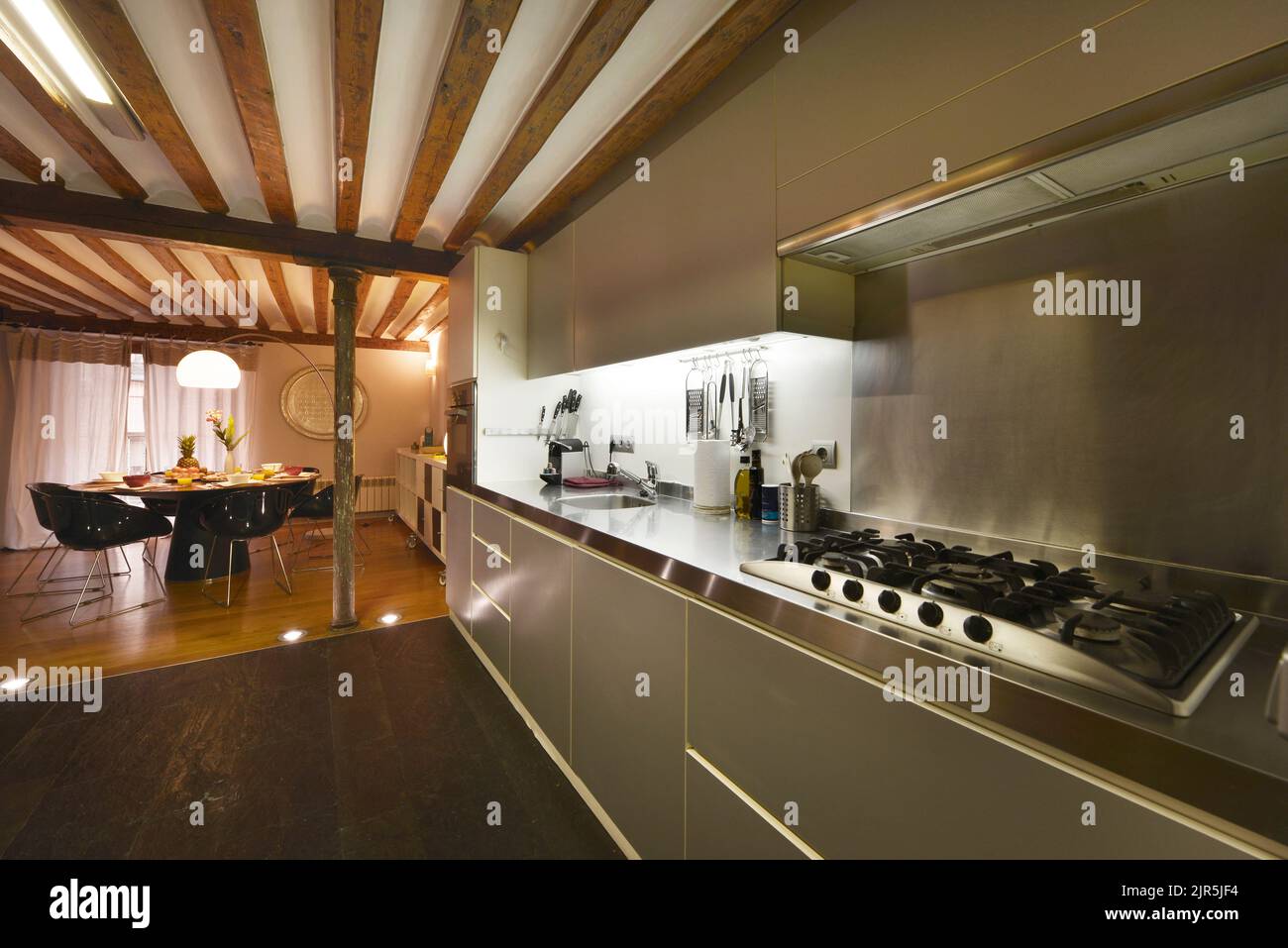 Large kitchen with brushed aluminum cabinets, stainless steel ...
