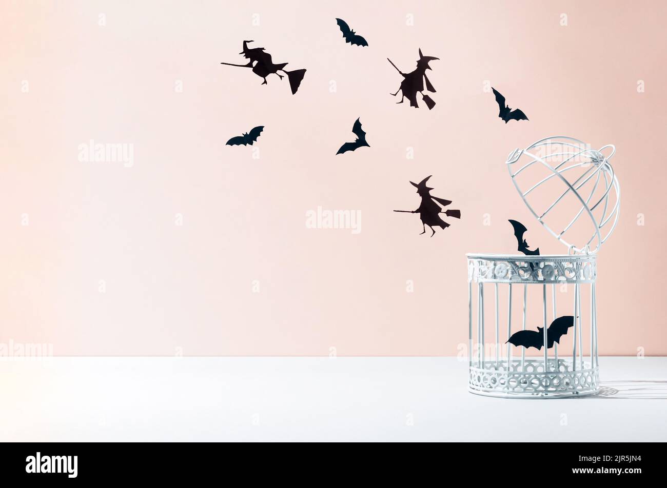 Creative minimal concept with bird cage, bats silhouettes and witches ...