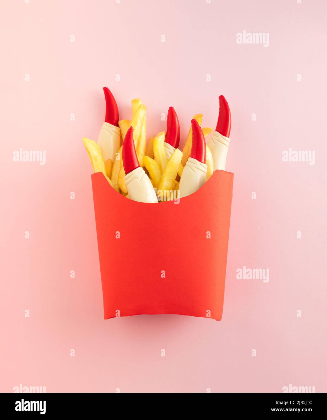 Minimal spooky concept made of french fries with witch's fingers in red ...
