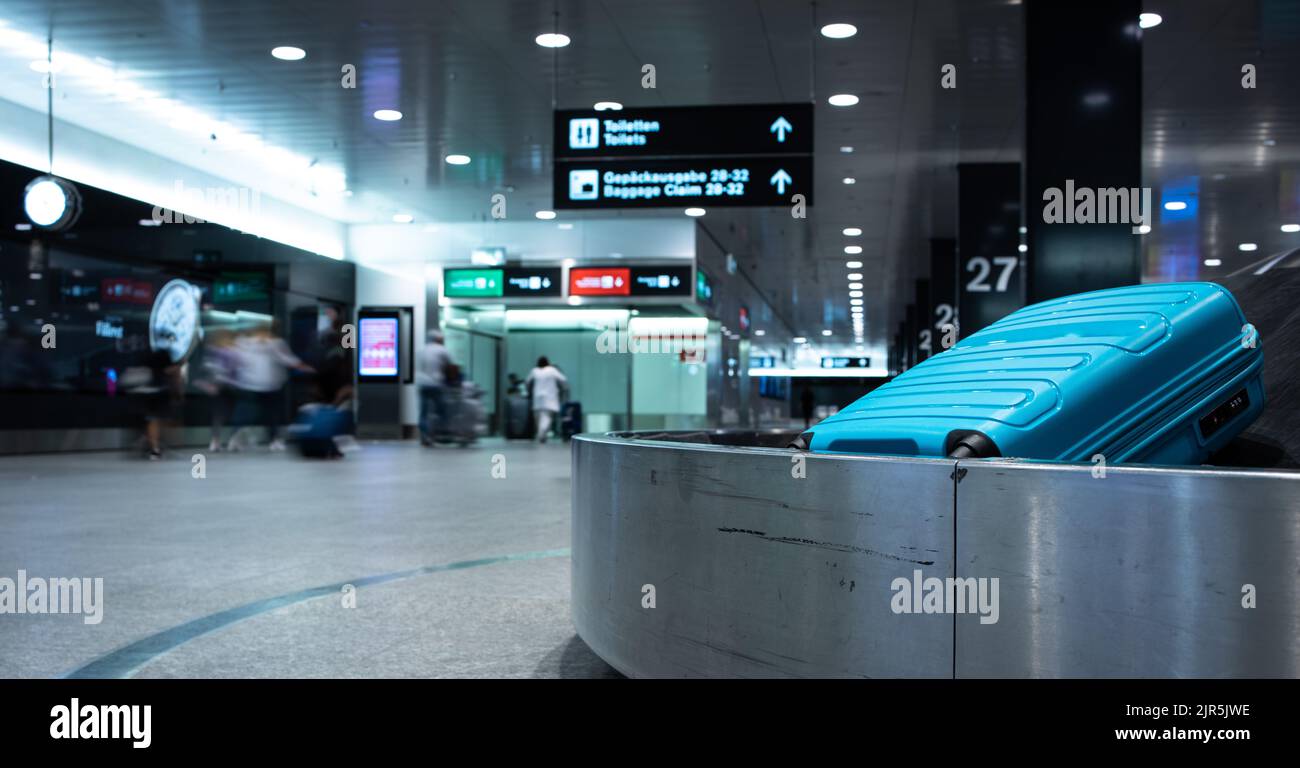 Arrived luggage going around on a conveyor belt waiting to be claimed ...