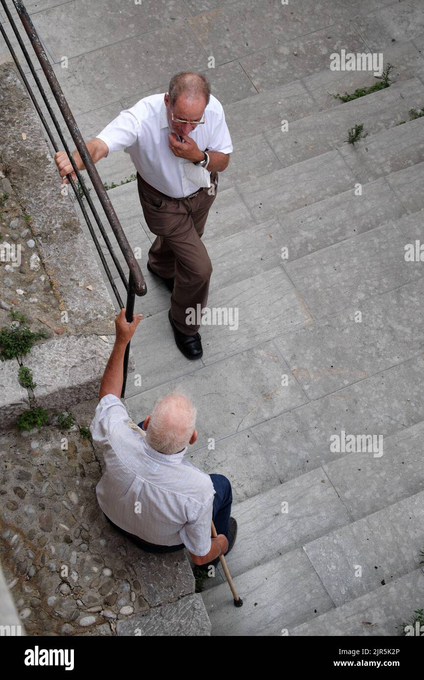 street photography conversation of two old men in a village of western ...