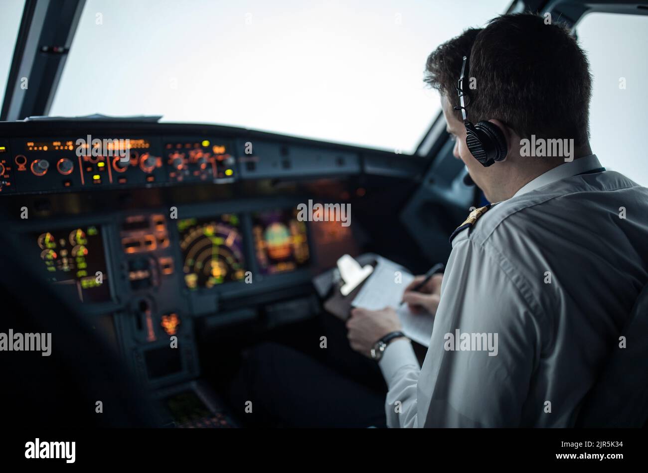 Pilot's hand accelerating on the throttle in a commercial airliner ...