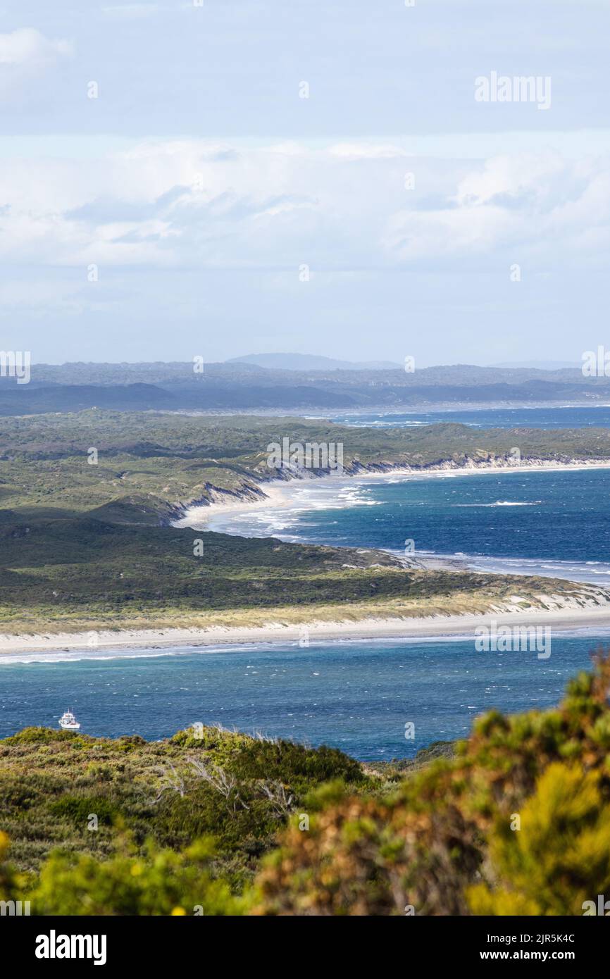 An aerial view of with coast Windy harbour surrounded by greenery hills ...