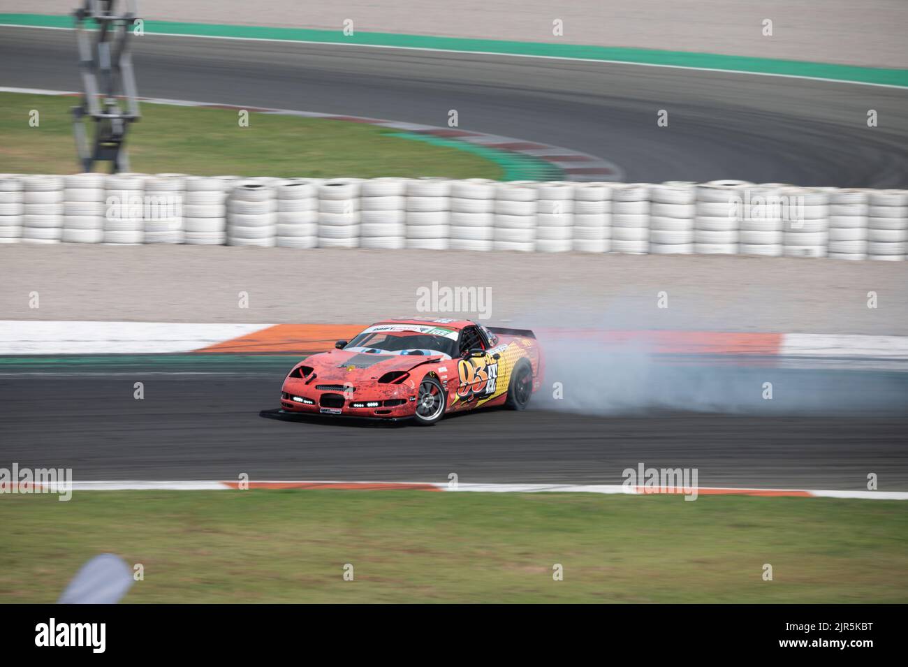 An orange Chevrolet Corvette C5 drifting on a competition trail Stock ...