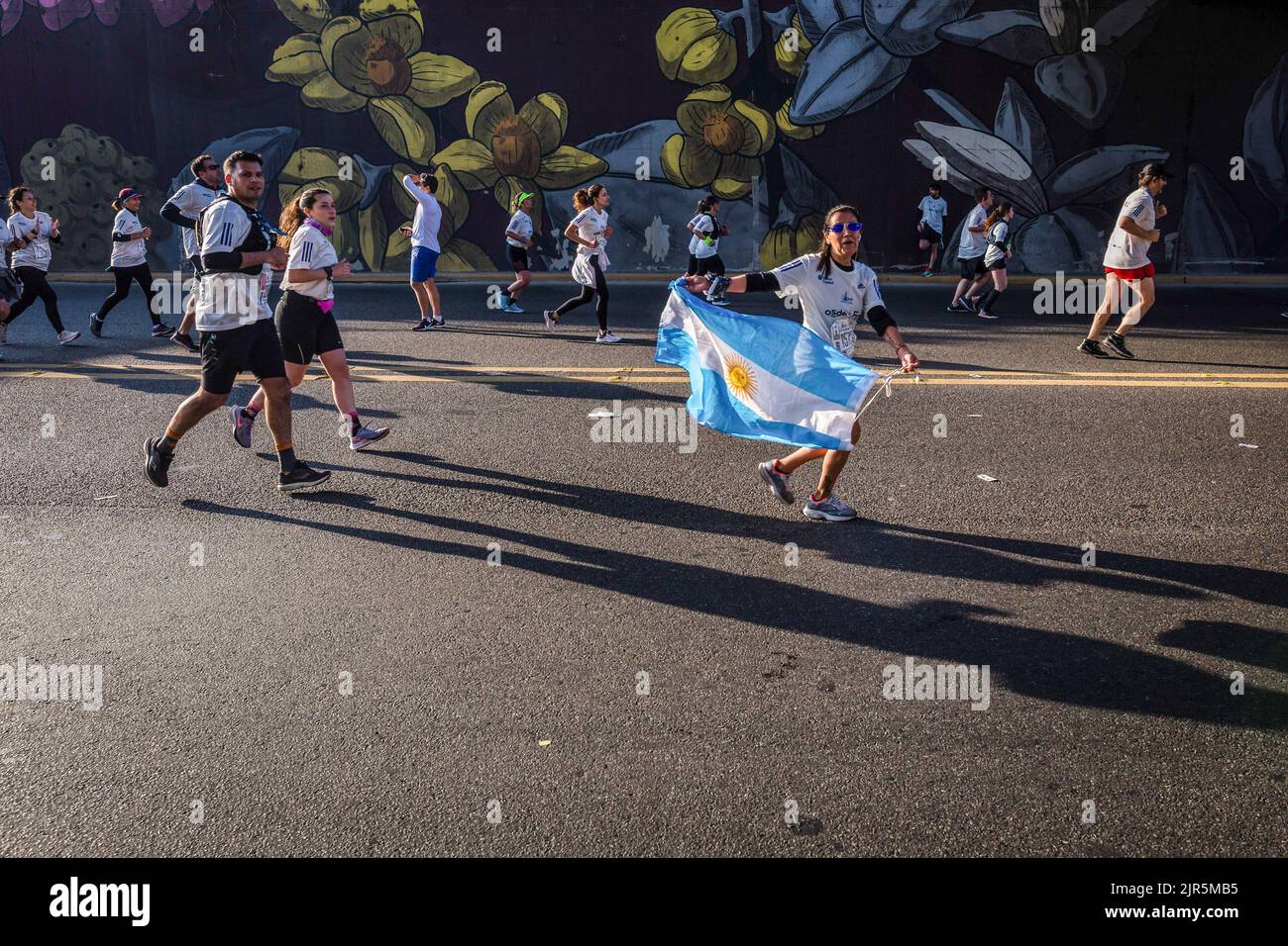 Buenos Aires, Argentina. 21st Aug, 2022. A runner carries an Argentine ...