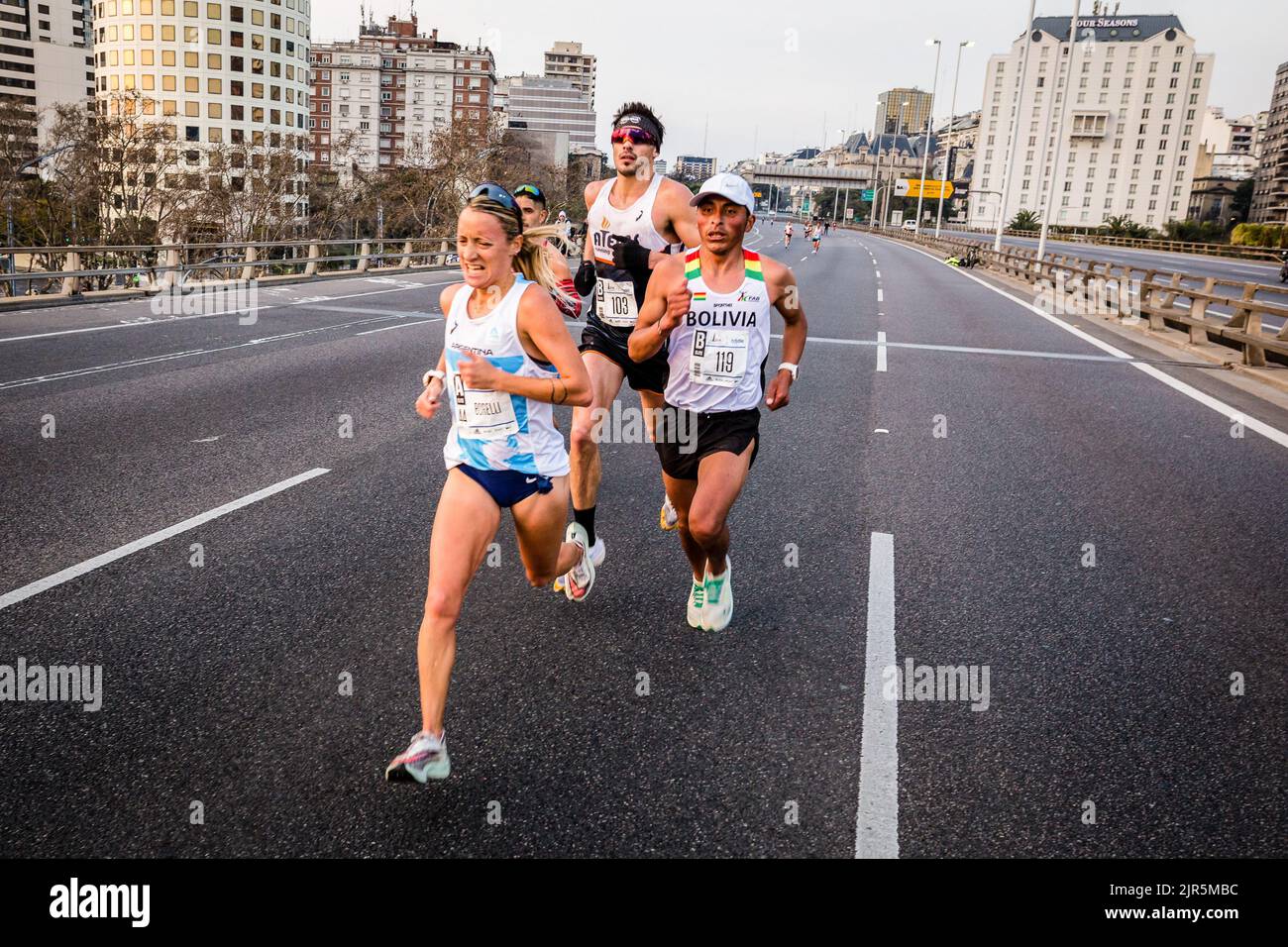 Buenos Aires, Argentina. 21st Aug, 2022. A woman leads a group of elite runners heading down the ...