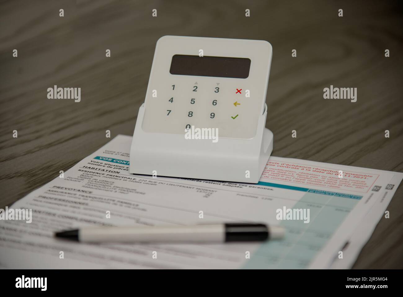 view of an invoice placed on a grey desk with a payment terminal Stock ...