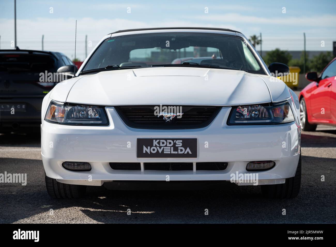 A clean white Ford Mustang GT convertible parked on a street Stock ...