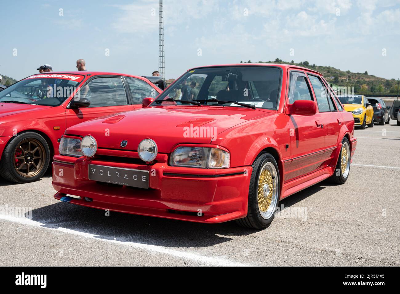 A classic red fourth generation Ford Escort parked on a road Stock ...