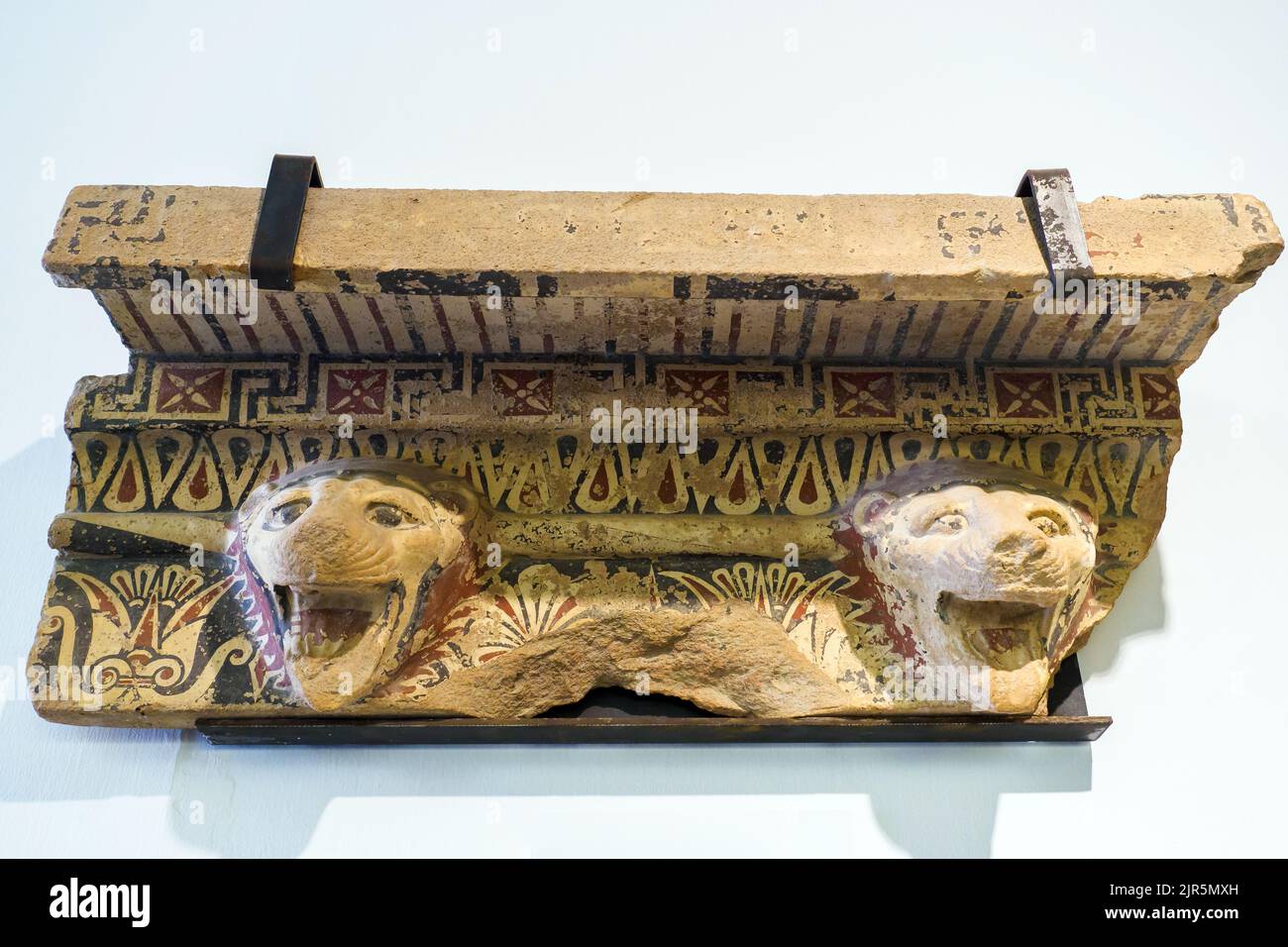 Terracotta gutter with fake dripstones in the form of lion's heads with ...