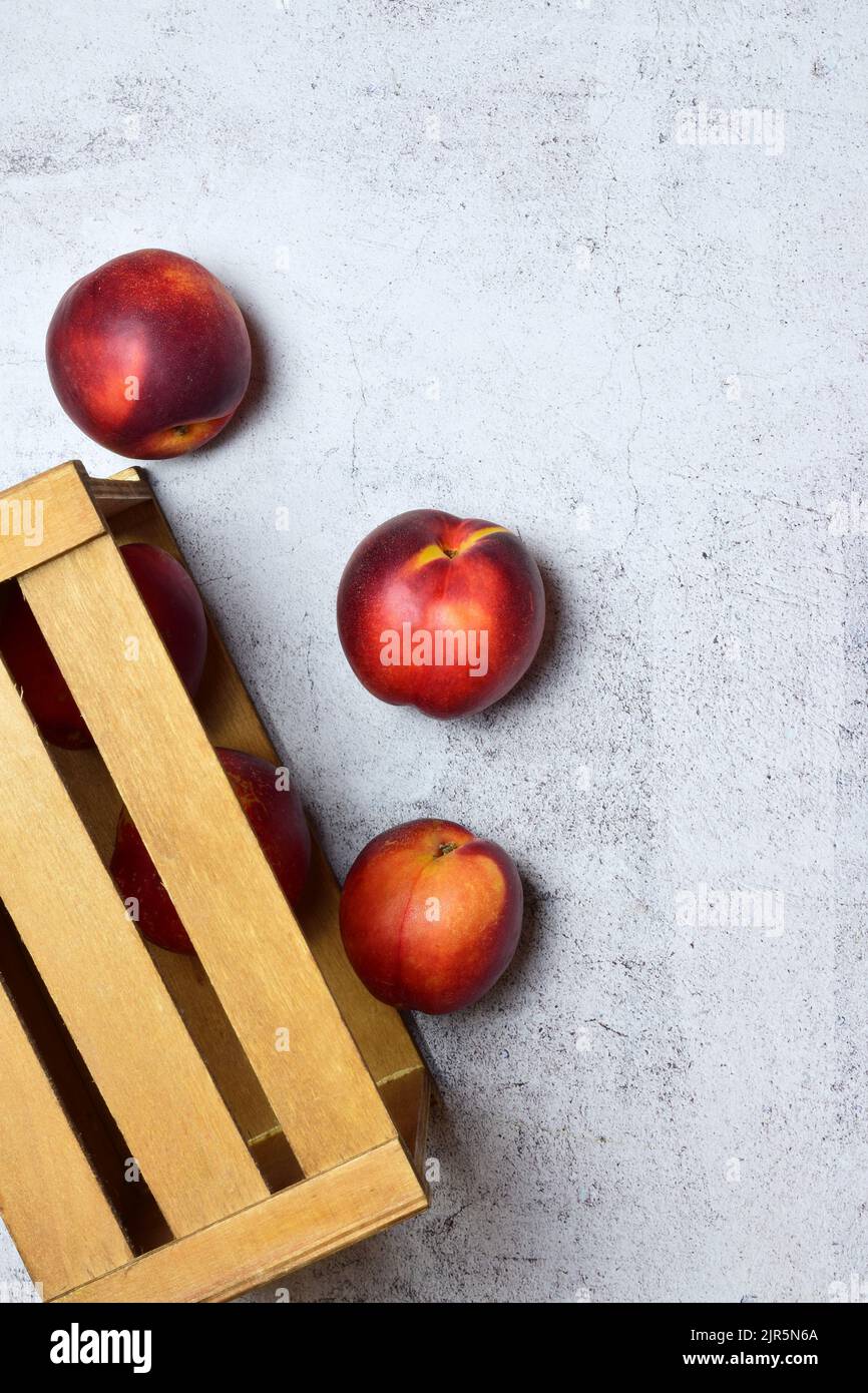 Fresh nectarines on a stone background Stock Photo - Alamy