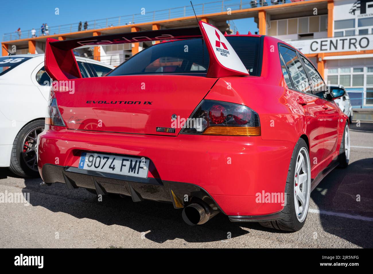 A classic red Mitsubishi Lancer Evolution IX parked at an exhibit Stock ...