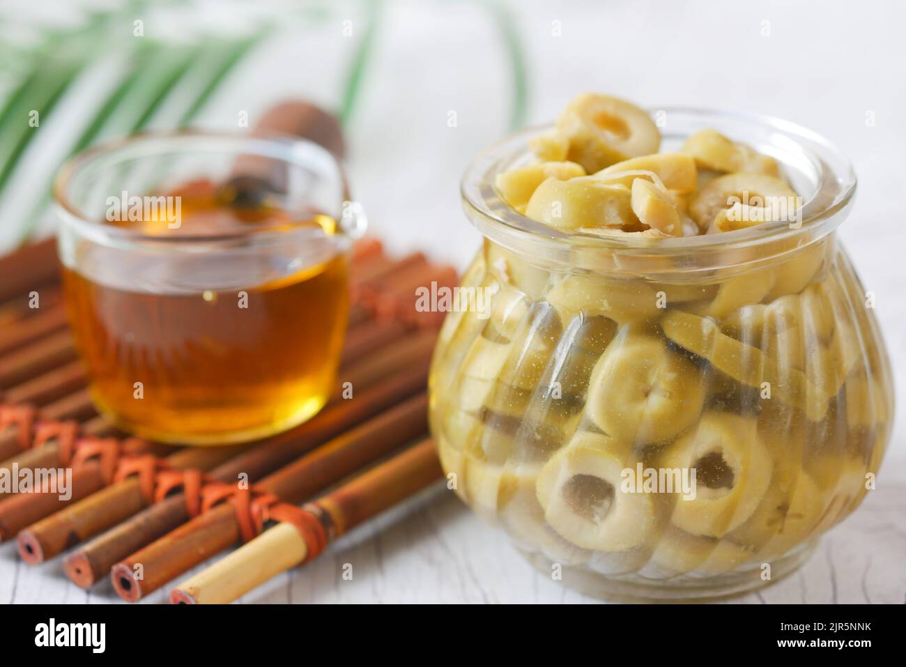 bottle of olive oil and fresh olive in a container on table Stock Photo ...