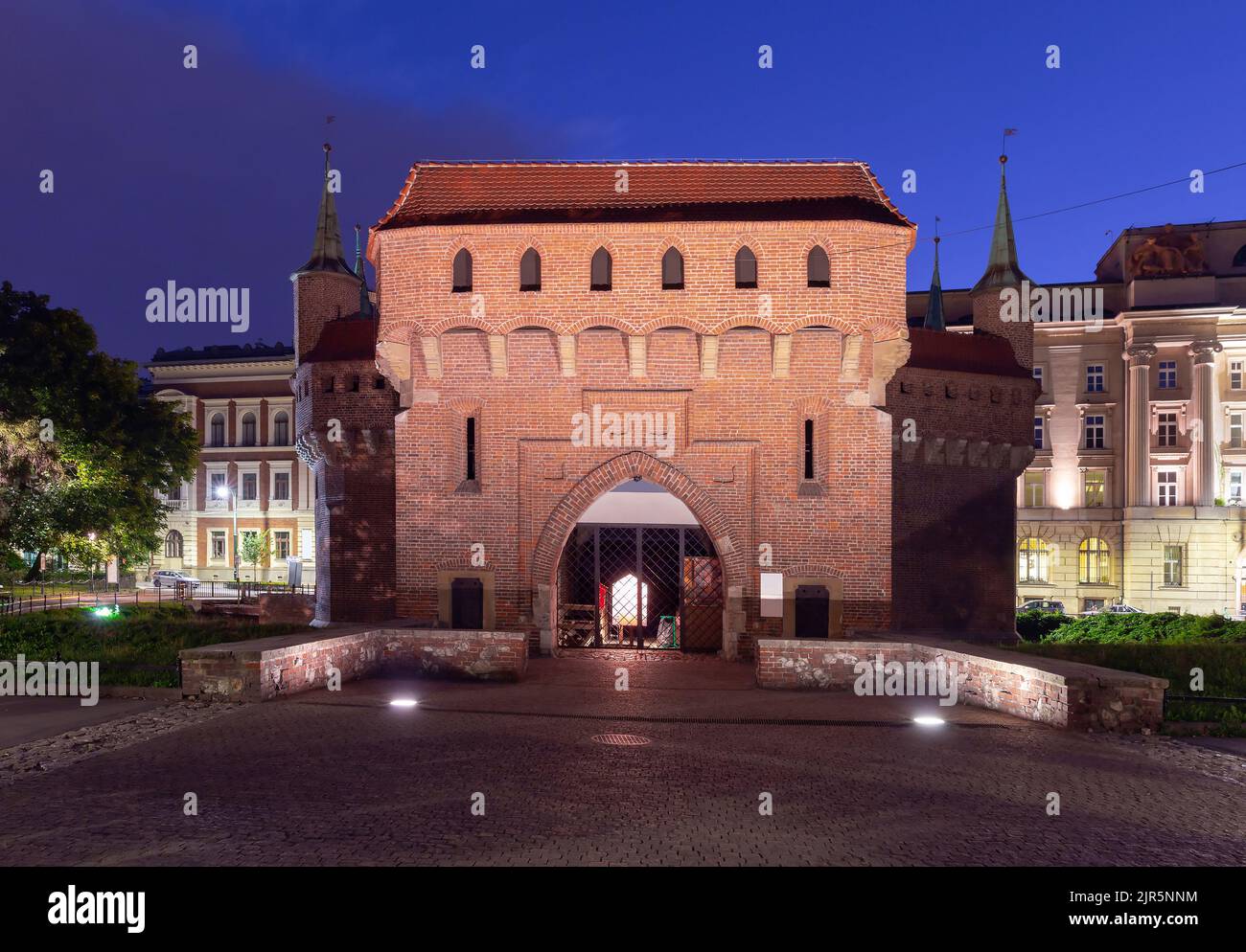 Stone building of the Barbican Fort in Krakow in the night illumination ...