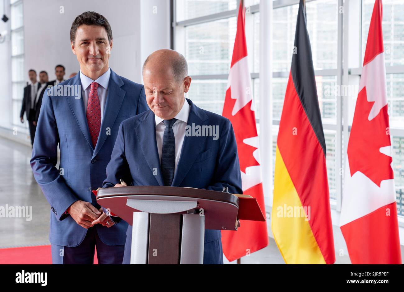 German Chancellor Olaf Scholz signs a guest book as Prime Minister ...