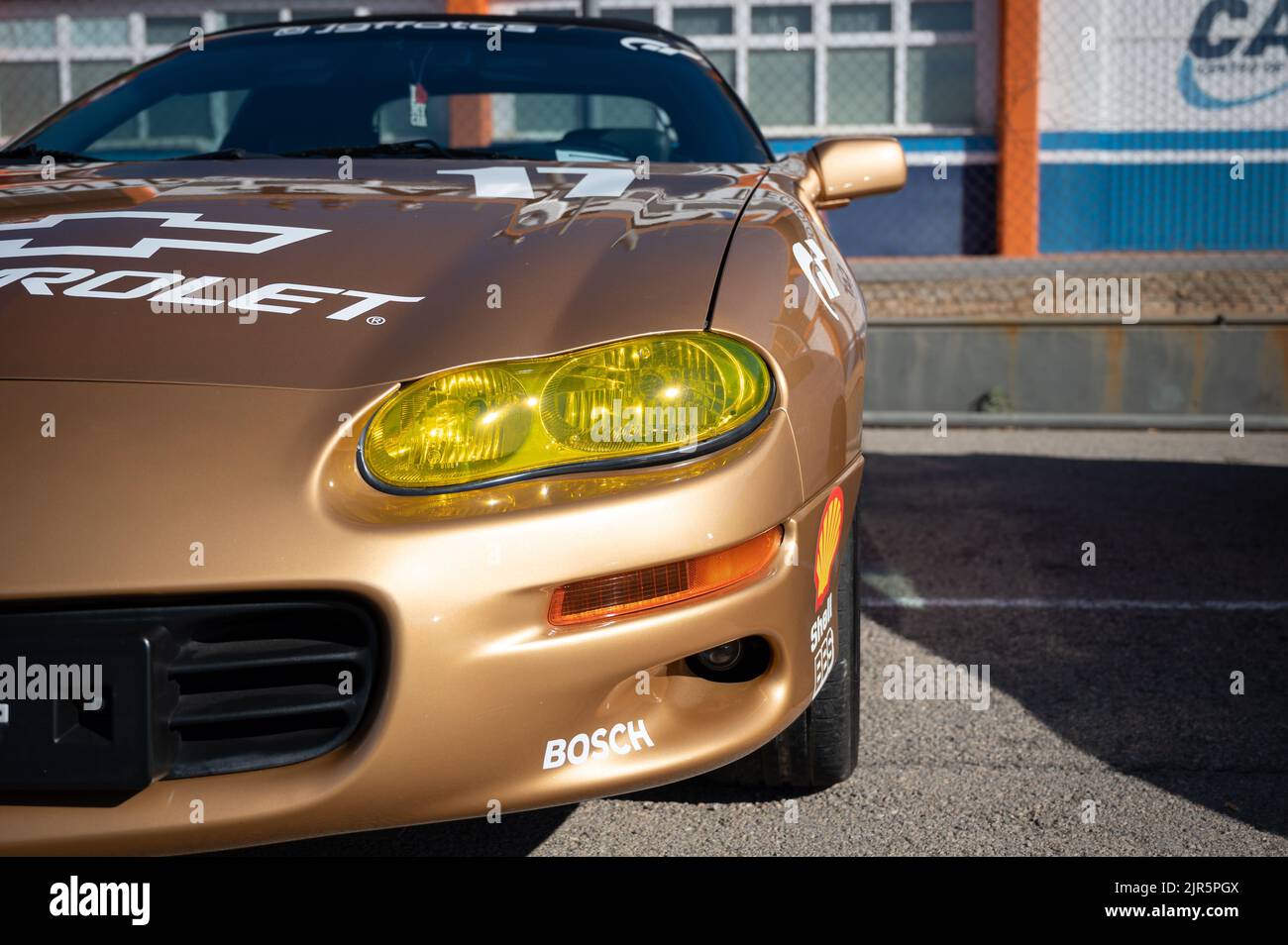 A golden 5th generation Chevrolet Camaro parked at an exhibit Stock ...