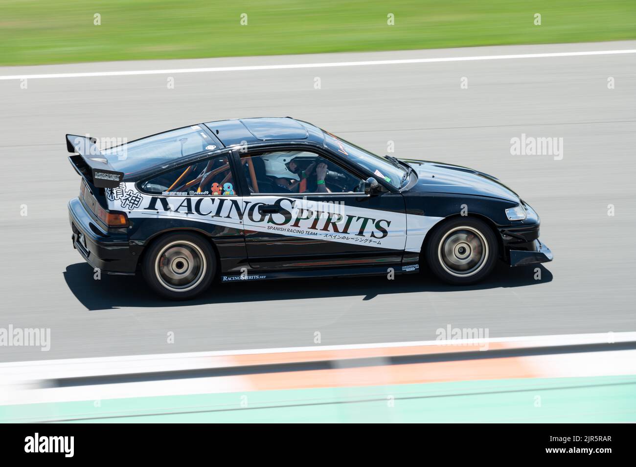 A small sports car Honda CR-X second generation in black racing around ...