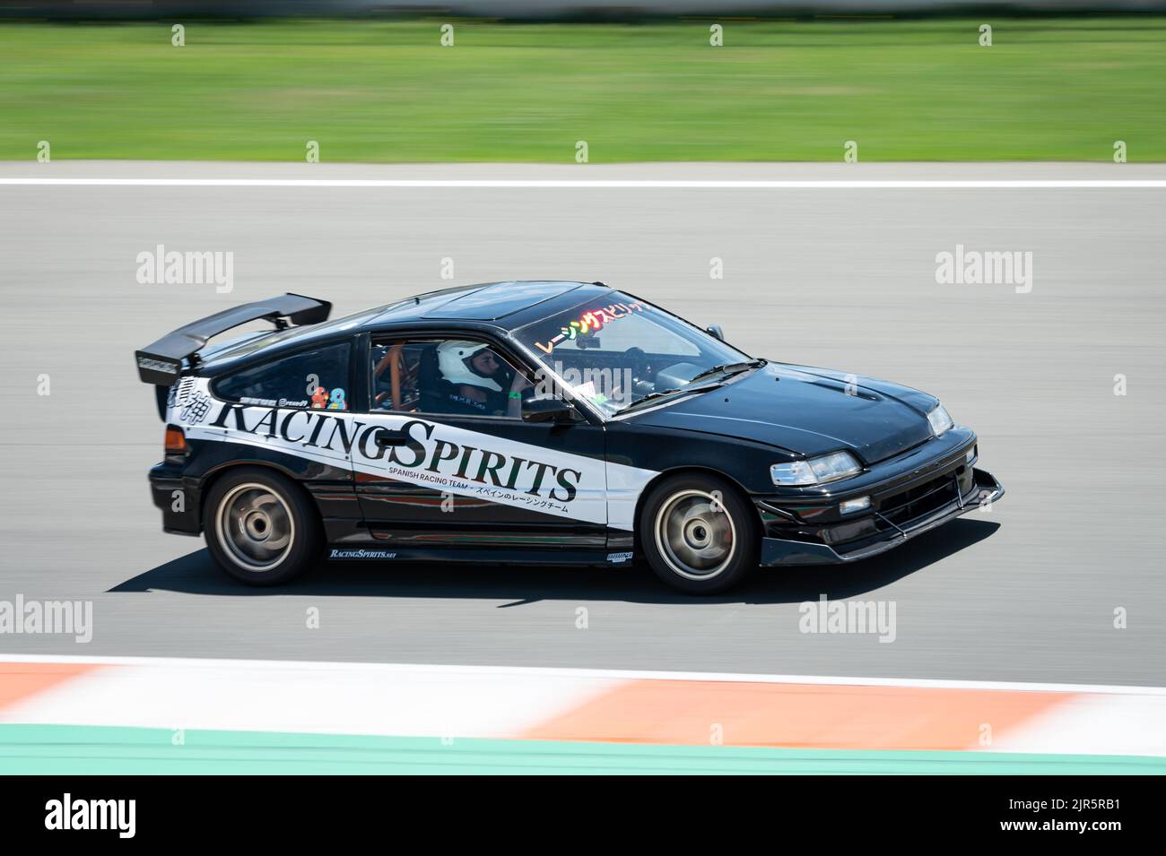 A small sports car Honda CR-X second generation in black racing around ...