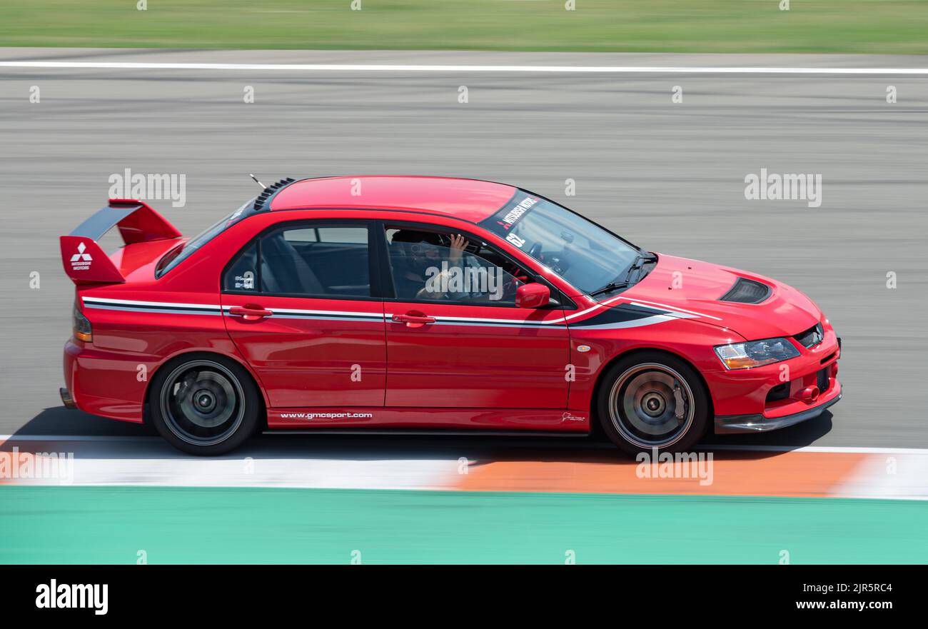A Japanese red Mitsubishi Lancer Evolution IX racing on a competition ...