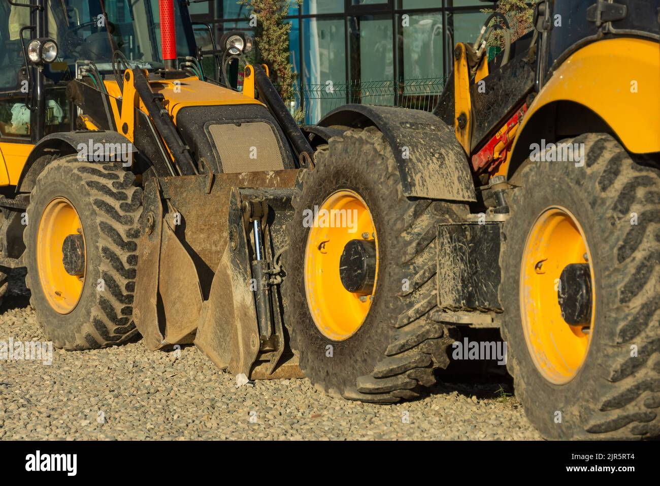 Wheels of two tractors in the mud in the parking lot during ...