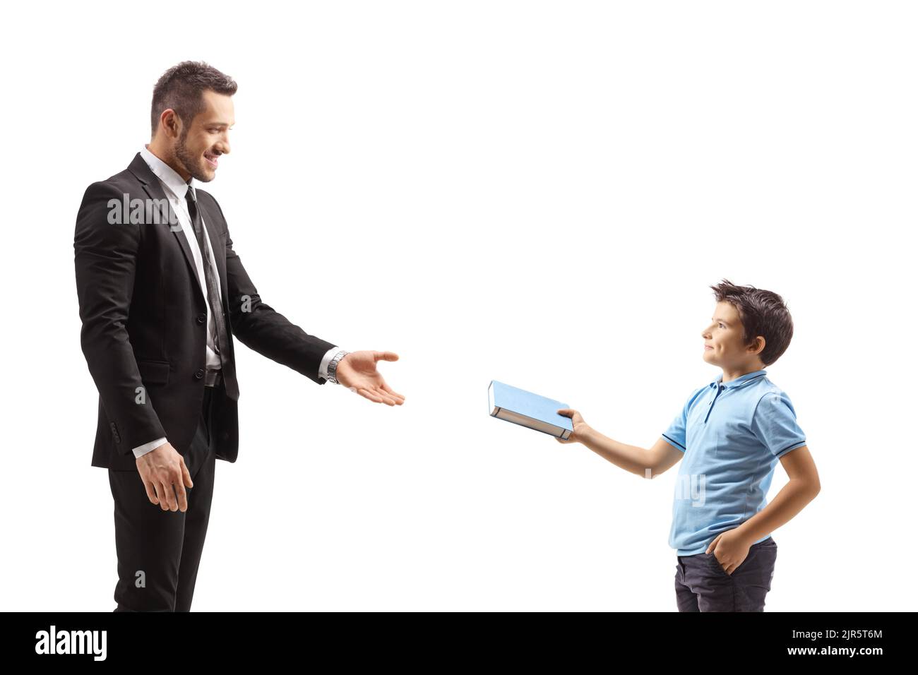 Boy giving a book to a businessman isolated on white background Stock ...