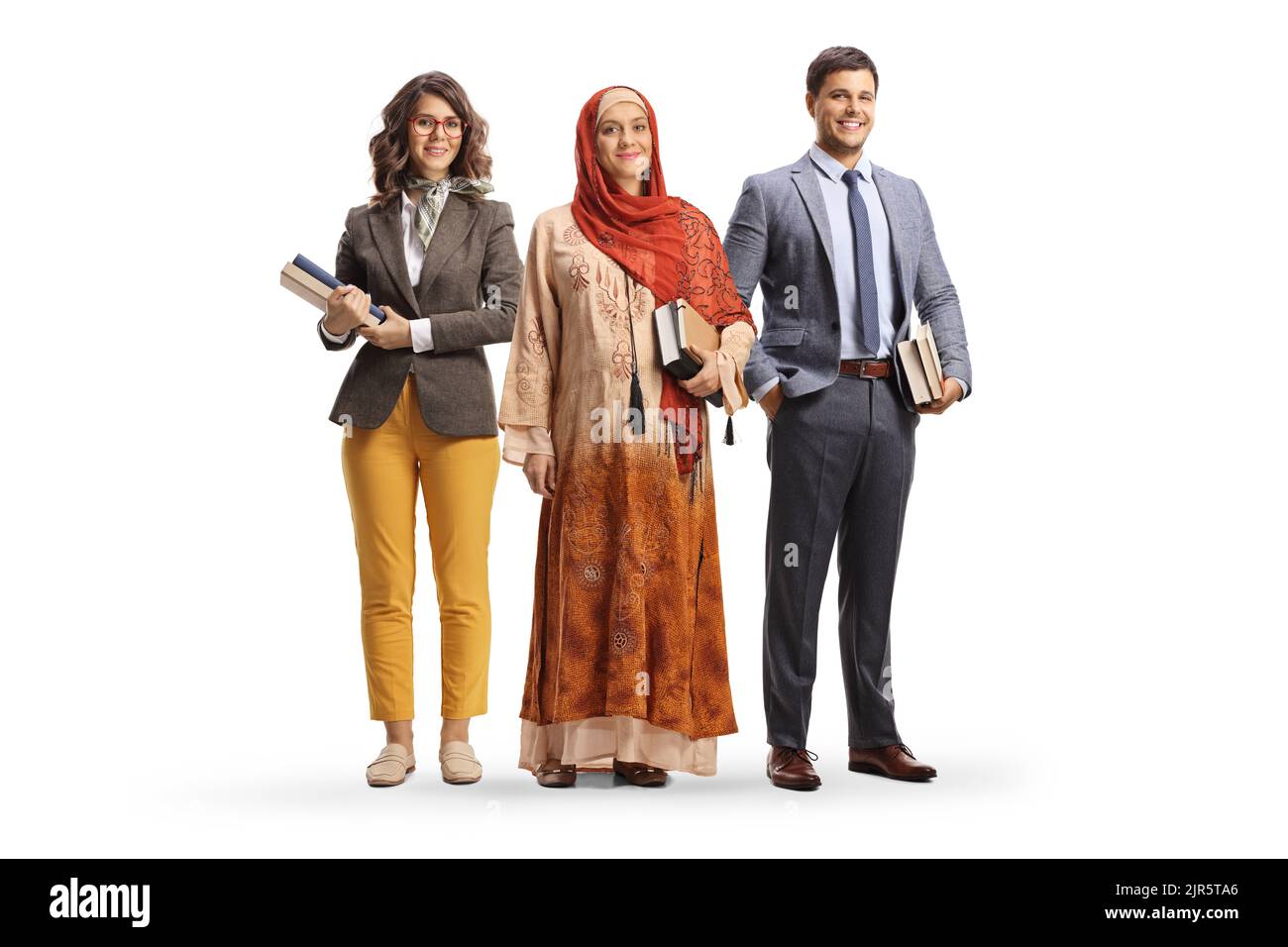 Teachers from different ethnicity holding books and posing isolated on ...