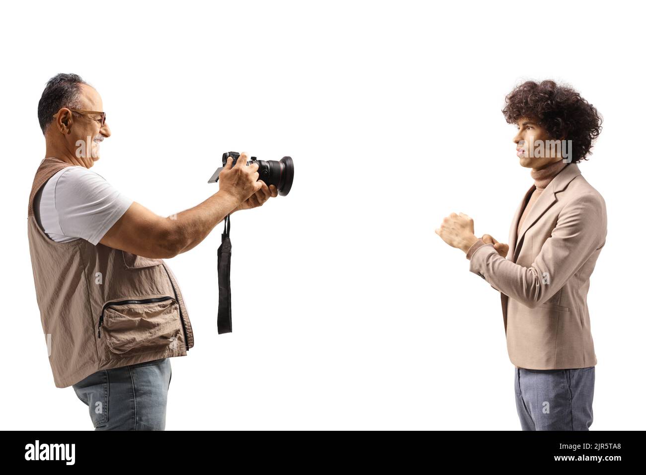 Photographer taking a photo of a young male model isolated on white ...