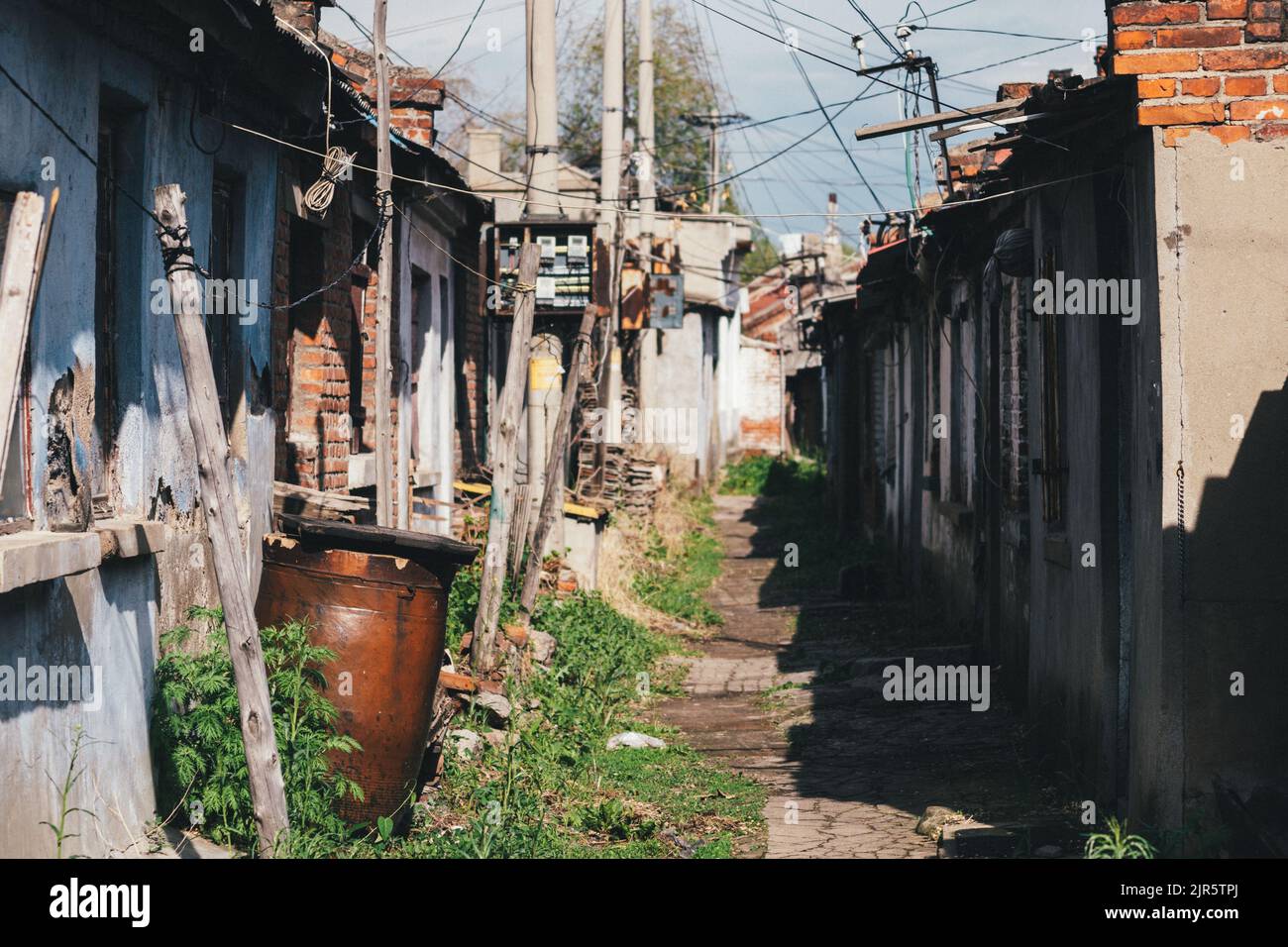 The view of an old poor narrow street under the blue sky Stock Photo ...