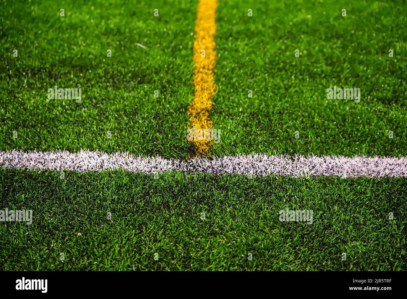 The high-angle partial view of the soccer field green grass with lines ...