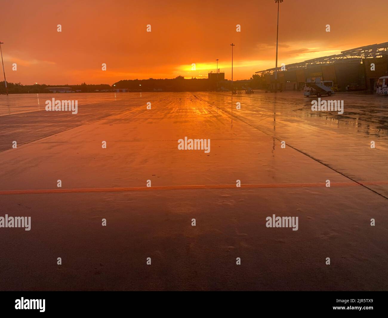 Airport runway in sunset light after the rain Stock Photo - Alamy