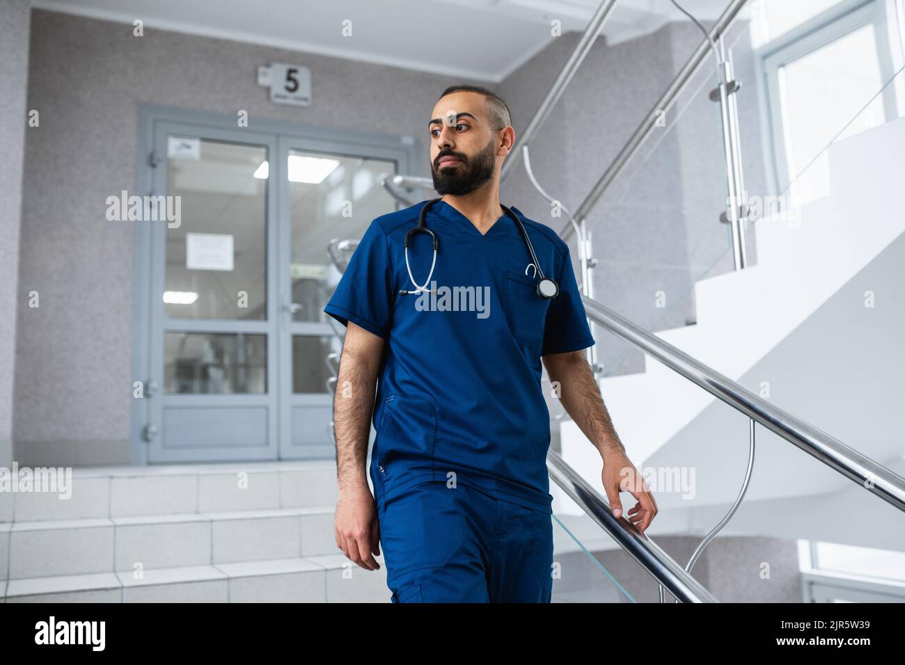 Professional surgeon on the stairs of the clinic Stock Photo - Alamy