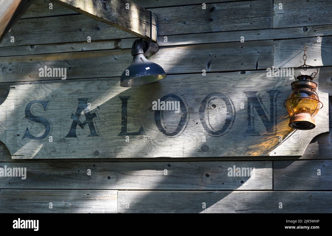 An old wooden signboard and oil lamp in a saloon Stock Photo - Alamy