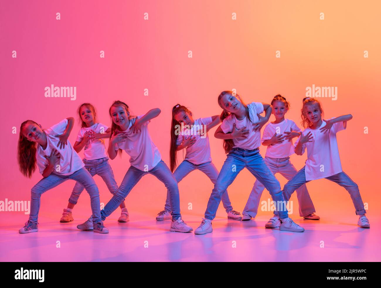 Group of school age girls, cheerful kids in casual style clothes ...