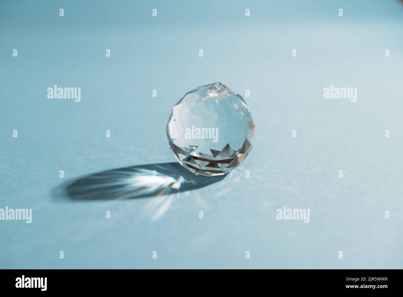 One crystals with light refraction on blue minimal background Stock ...