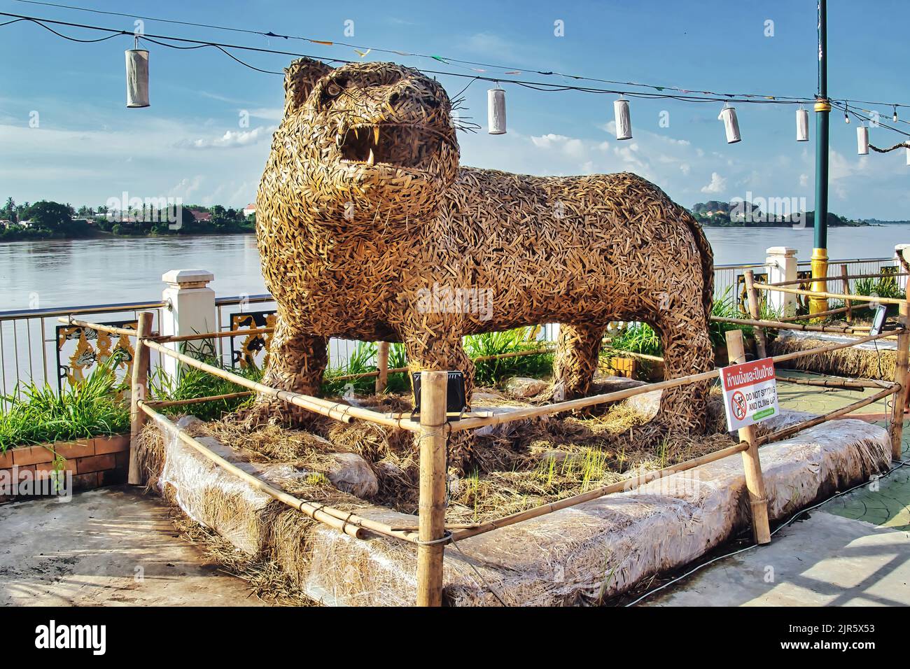 Statue of a tiger, made entirely of rattan, on the riverside promenade ...