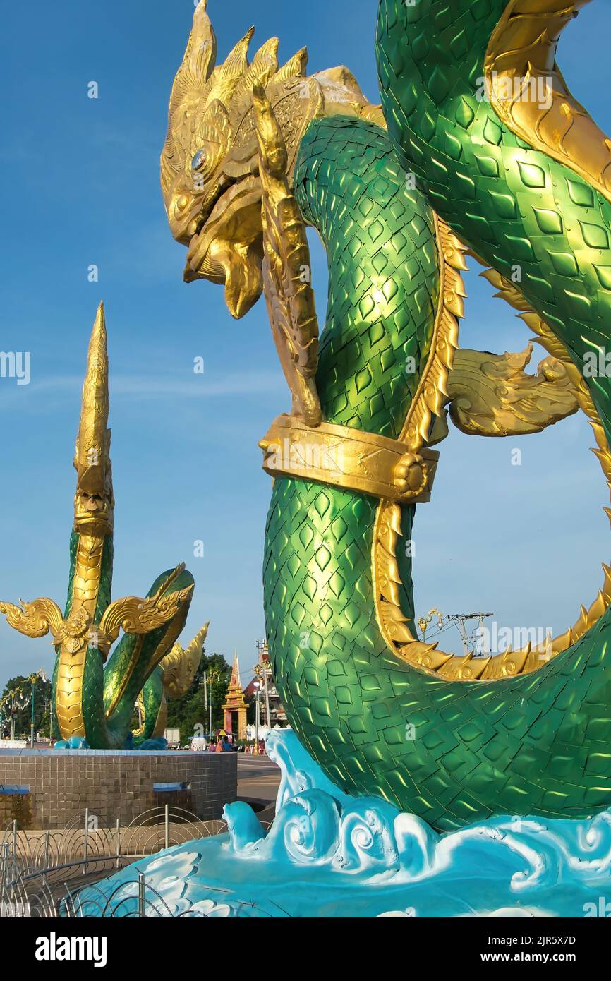 Large statues of green and gold nagas (mythical serpents) on the Mekong ...