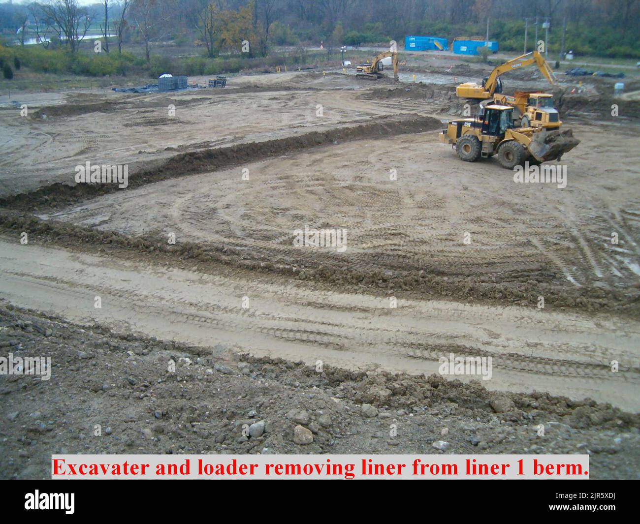 Excavater and loader removing liner from liner 1 berm facing Southwest ...